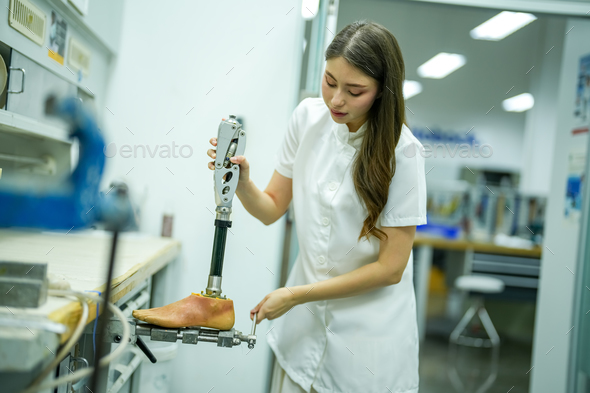 Orthopedic technician making prosthetic leg for disabilities people in workshop. Stock Photo by ...
